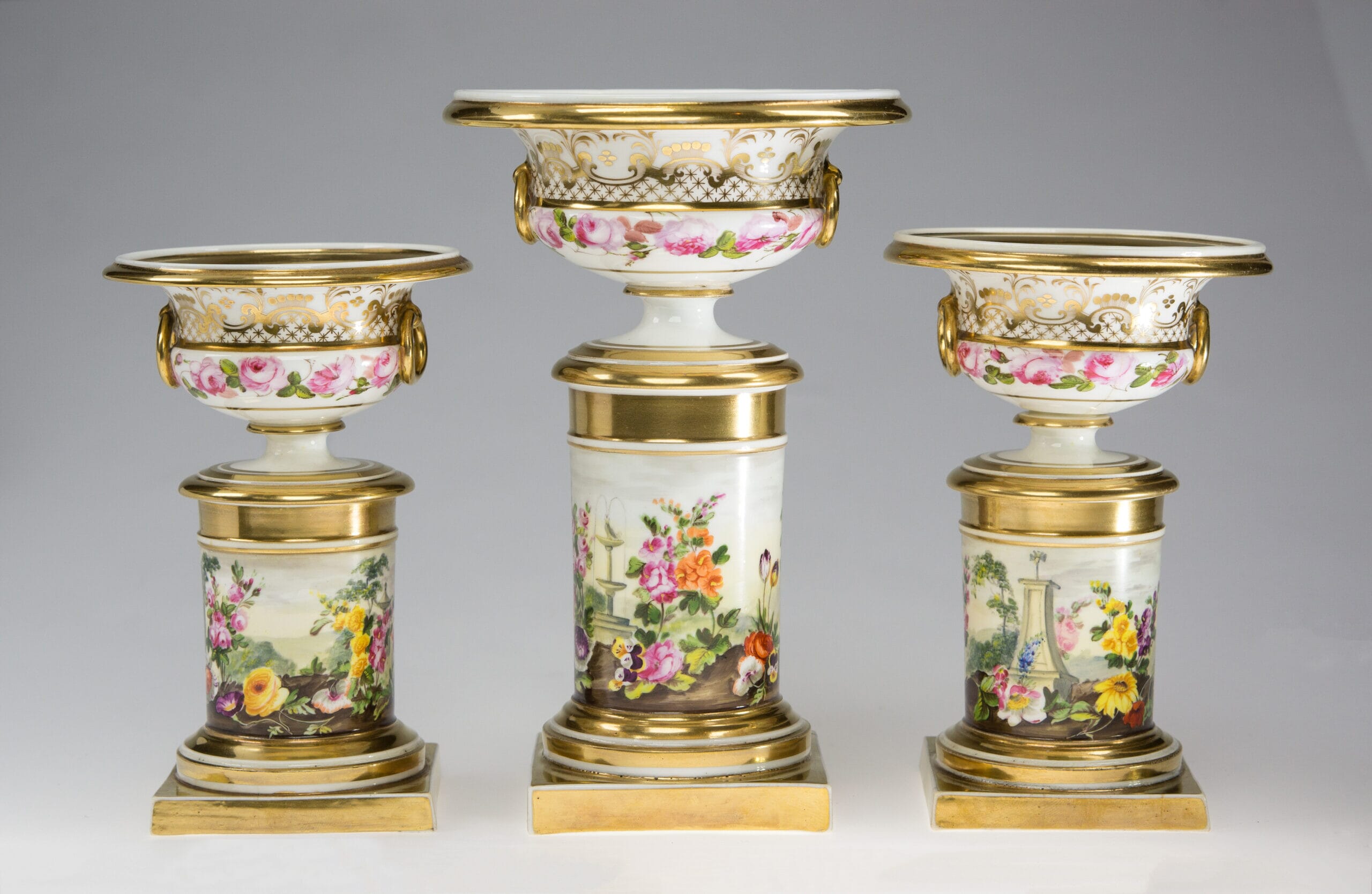 Daniels Porcelain garniture of urns on pillars, garden landscapes, c ...
